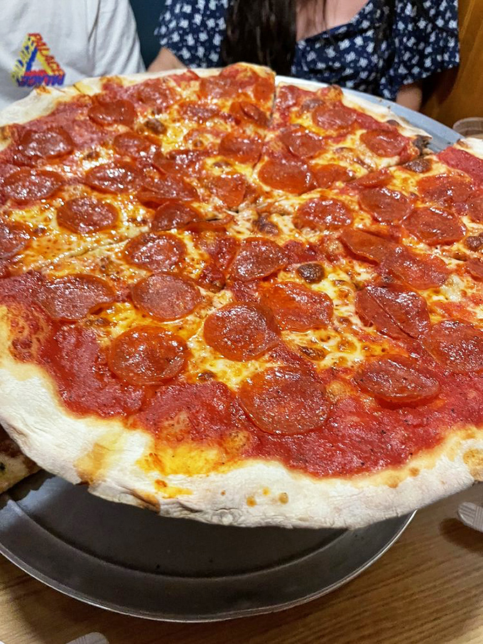 A spinach and tomato masterpiece that makes eating vegetables feel like cheating at your diet. That crust deserves its own fan club.