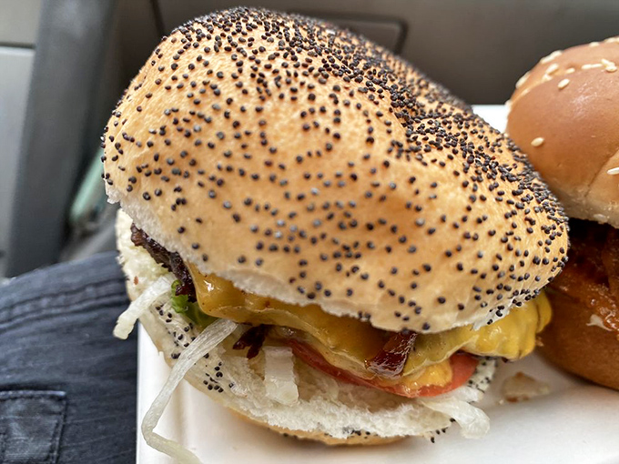 The poppy seed bun burger - where every bite delivers that perfect balance of savory beef, melty cheese, and garden-fresh toppings.