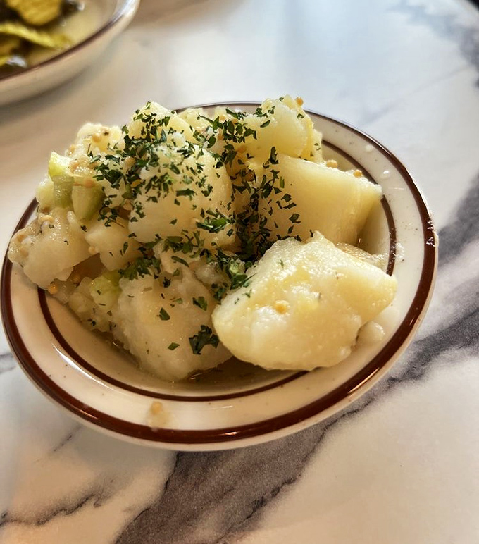 Potato salad that'll make you question everything you thought you knew about spuds. It's like a hug for your taste buds, with a sprinkle of herbs for good measure.