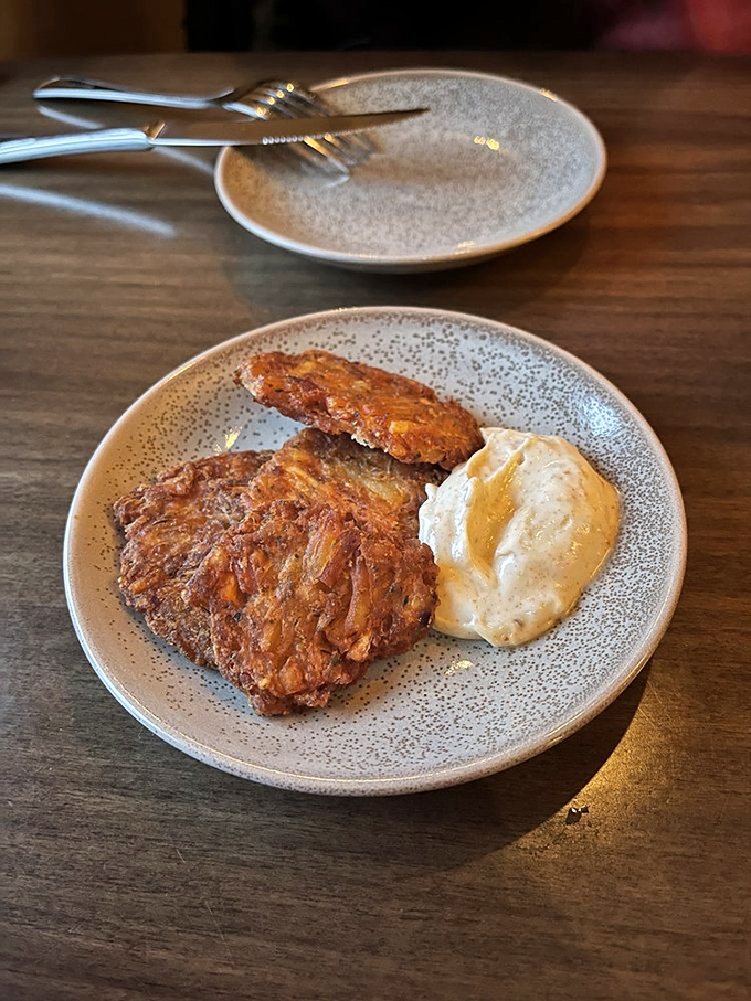 Crispy potato cakes with a side of creamy sauce&mdash;proof that sometimes the humblest ingredients make the most memorable bites. Comfort food, elevated. 