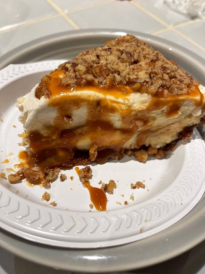 The praline cheesecake's cascade of caramel and pecans isn't just a topping &ndash; it's nature's perfect hat for dairy's perfect creation.