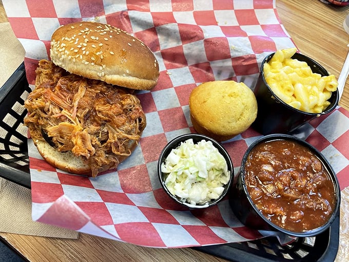 A pulled pork sandwich that's practically bursting at the seams, surrounded by sides that aren't afterthoughts but worthy companions on this culinary journey.