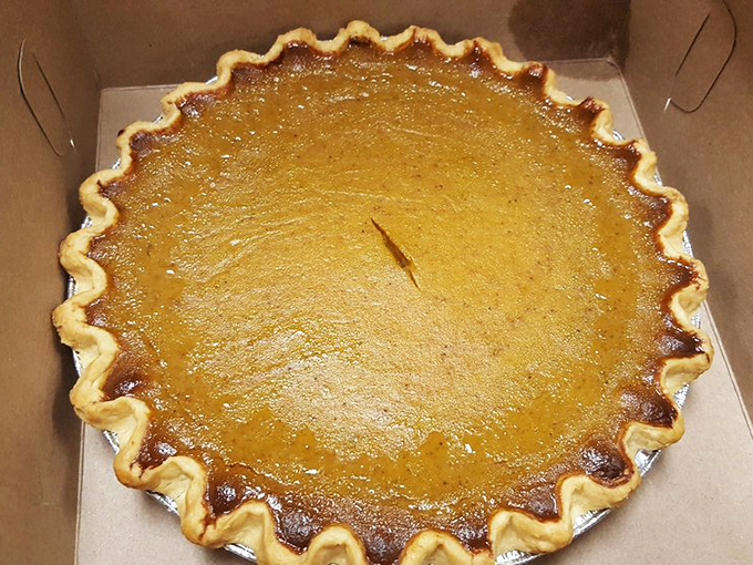 The humble pumpkin pie, elevated to art form. That crimped crust edge deserves its own museum exhibit.