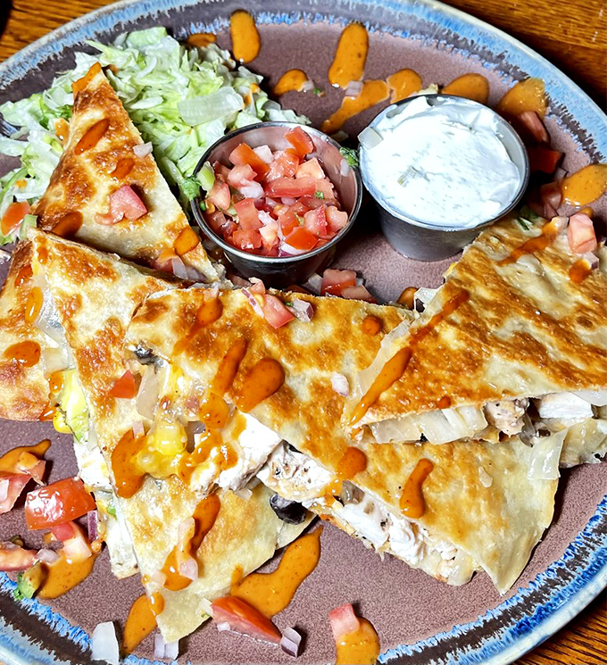 These fish tacos don't just speak&mdash;they sing with fresh avocado, tangy sauce, and perfectly crisp fish. Worth every napkin you'll need.