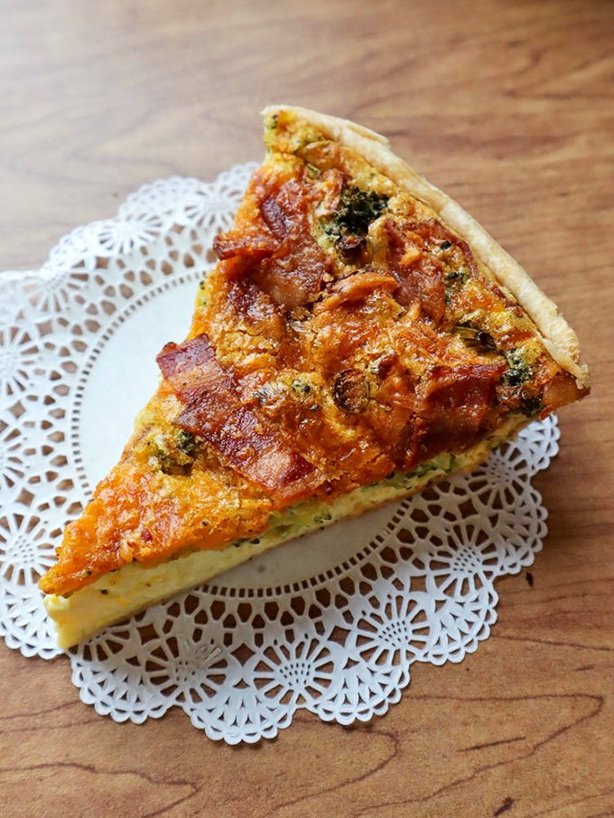 This quiche doesn't just sit there looking pretty on its doily throne&mdash;it broadcasts "I contain multitudes of flavor" with every golden-baked inch.