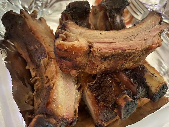 Ribs with that perfect pink smoke ring and bark that would make a tree jealous. The kind that leave evidence on your shirt and zero regrets.