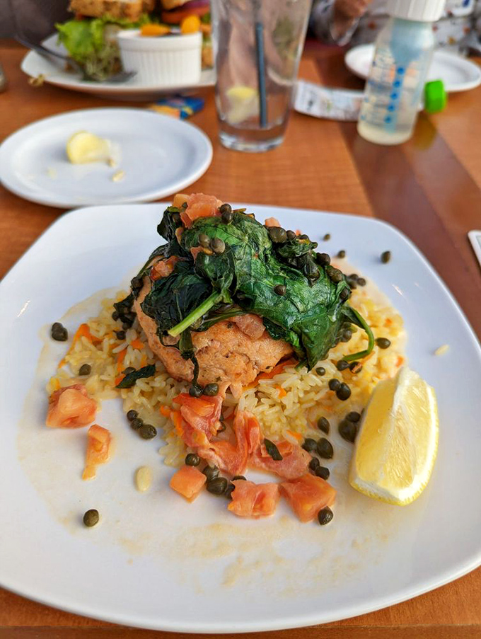 Salmon perched atop saffron rice with capers playing hide-and-seek throughout&mdash;seafood architecture that's almost too pretty to eat. Almost.