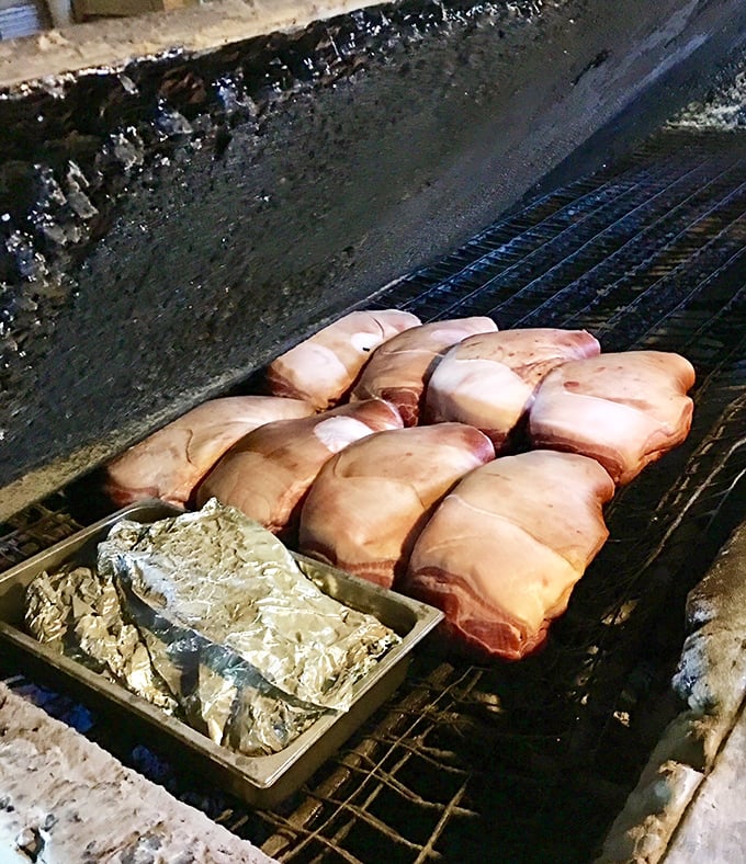 The sacred ritual begins before dawn. Pork shoulders await their transformation through smoke and time into something transcendent.