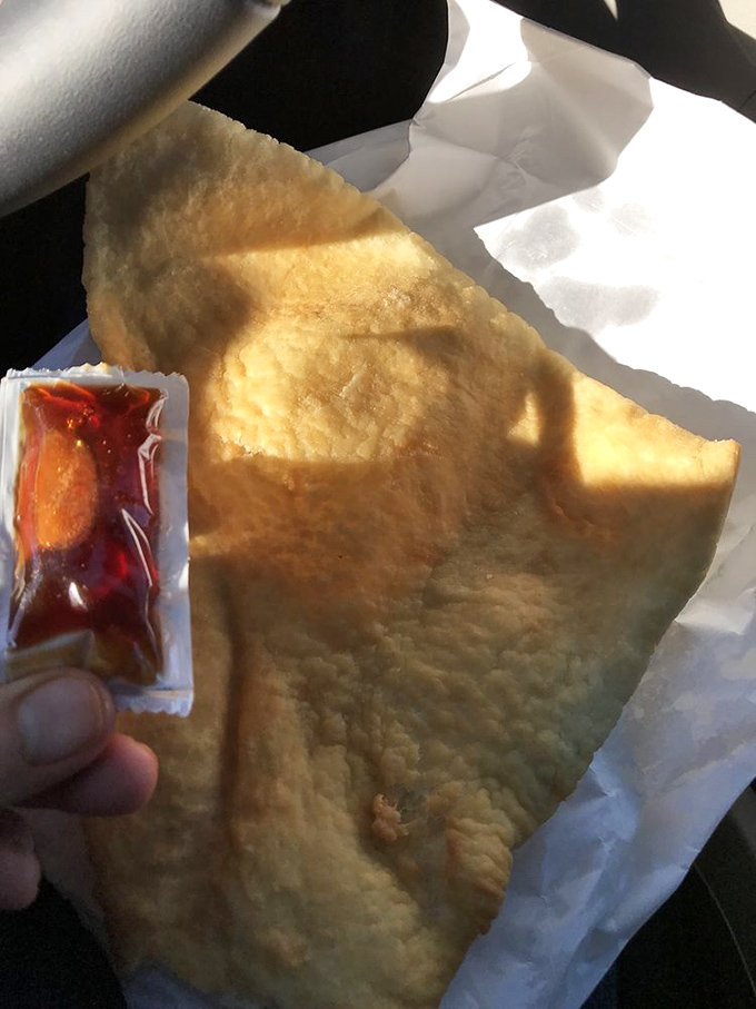 The sopapilla—a pillowy cloud of fried dough—waits for its honey bath like a desert wanderer dreaming of an oasis.