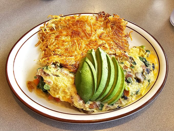 An omelet that proves California knows its vegetables. Those perfectly fanned avocado slices aren't just garnish&mdash;they're a statement of intent.