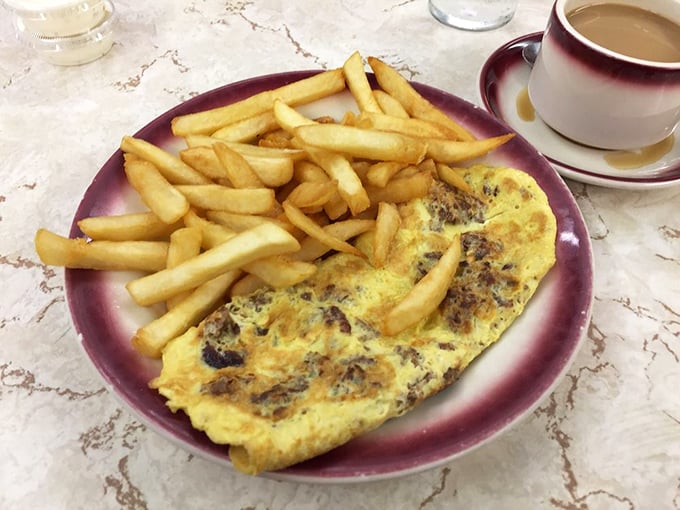 When your omelet shares a plate with perfectly golden fries and a cup of diner coffee, you understand why some culinary traditions never need updating.
