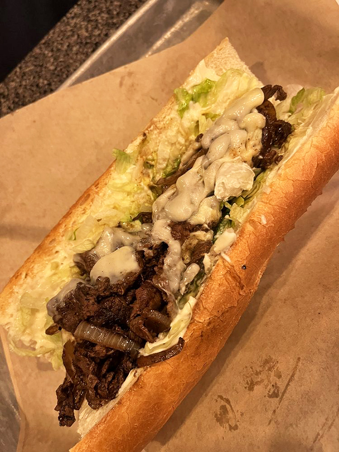 This isn't just a sandwich, it's a French dip miracle – tender steak, melted cheese, and that magical sauce.