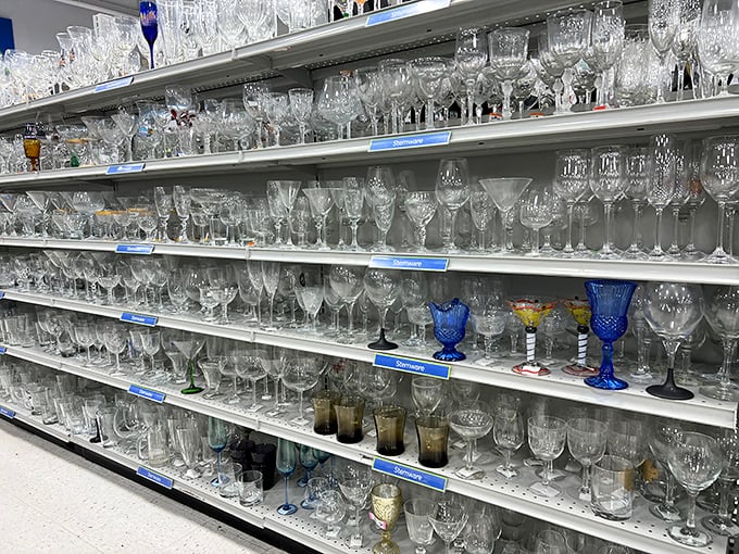 Crystal and glassware gleam under fluorescent lights like an elegant party frozen in time. Somewhere, a dinner table is waiting for these long-stemmed beauties.