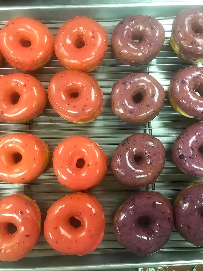 The technicolor dream donuts that make your inner child do backflips. These fruity glazes aren't just toppings&mdash;they're edible stained glass windows to happiness.
