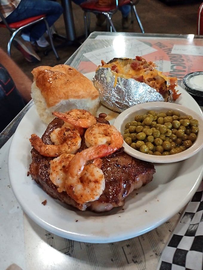 Land meets sea in perfect harmony&mdash;a juicy steak crowned with seasoned shrimp, alongside a loaded baked potato that's practically begging to be devoured.
