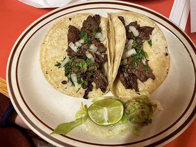 These Tacos de Asada don't need fancy outfits&mdash;just perfectly grilled beef, fresh cilantro, diced onions, and a lime wedge that's practically begging to be squeezed.