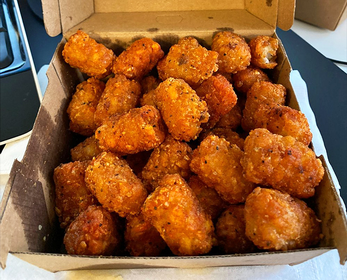 These aren't your cafeteria tater tots. They're crispy little flavor grenades that explode with satisfaction in every bite.