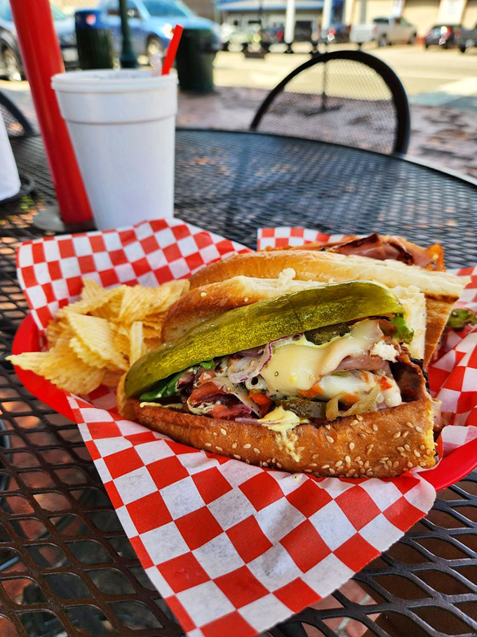 Outdoor dining with pickle spear sentinels&mdash;because some sandwiches deserve fresh air and admiring glances from passersby.