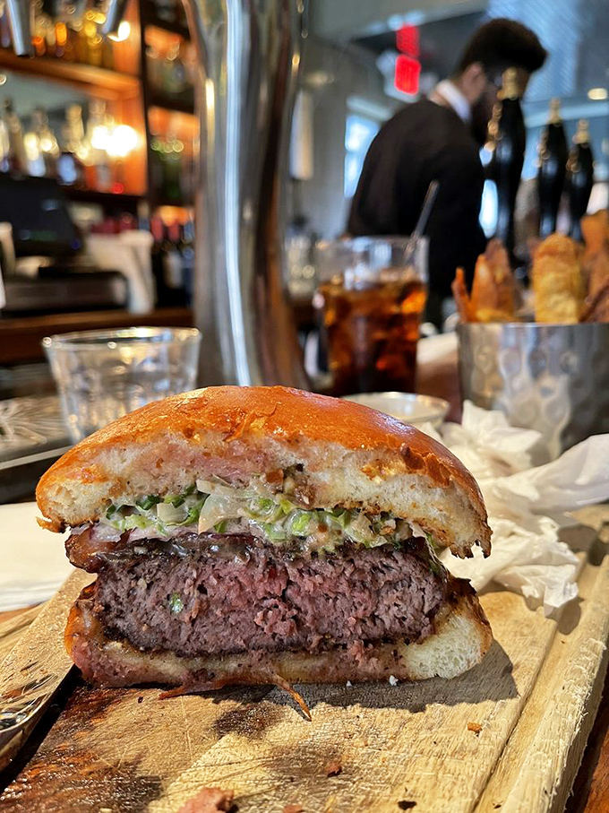 This burger isn't just a meal, it's a revelation&mdash;medium-rare perfection peeking through a toasted bun with the kind of structural integrity that prevents the dreaded mid-bite collapse.