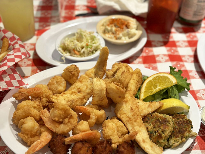 This seafood platter doesn't just feed two&mdash;it creates memories. Hushpuppies, fried shrimp, and crab cakes arranged like treasures on a red-checkered map.