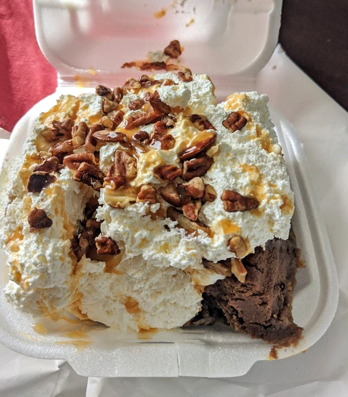 The Turtle Cheesecake looks like it's auditioning for a dessert magazine cover with its mountain of whipped cream and perfectly placed pecans.