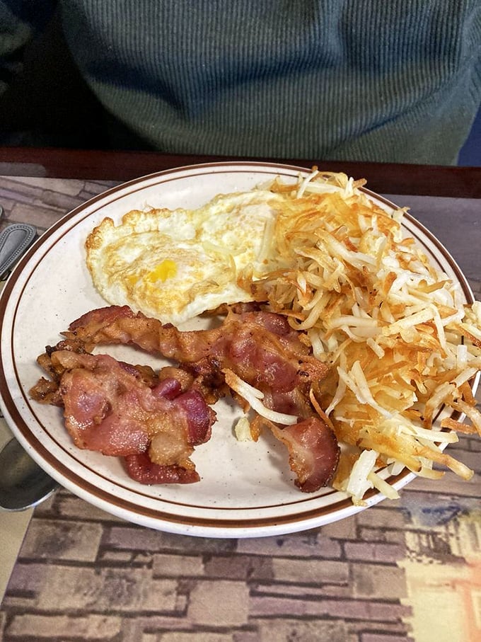The classic two-egg breakfast with bacon and hash browns&mdash;proof that sometimes the simplest combinations create the most satisfying symphonies.