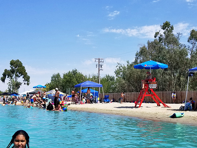 The beach area transforms into a colorful patchwork of umbrellas, towels, and people experiencing the unique joy of being completely exhausted while completely relaxed.