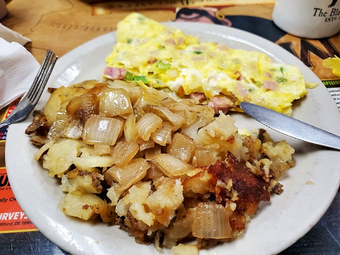 The Western omelet arrives with home fries that have achieved the holy grail: crispy exteriors giving way to pillowy potato interiors.
