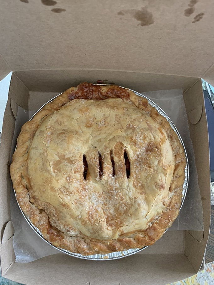 Golden lattice work worthy of architectural awards keeps watch over bubbling fruit treasure&mdash;pie engineering at its finest.