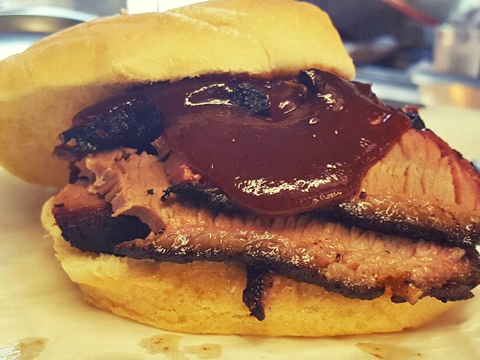 The brisket sandwich: where hickory-smoked heaven meets a humble bun, creating a handheld masterpiece worth driving for.