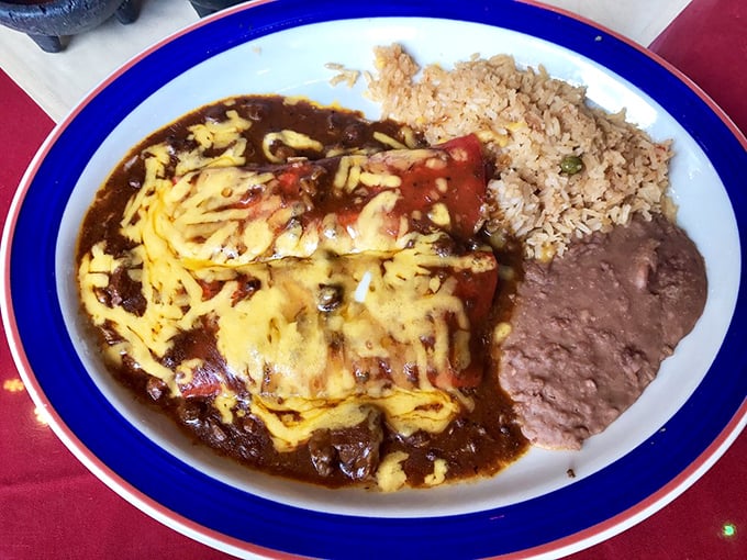 Cheese-topped enchiladas bathed in rich sauce alongside perfectly fluffy rice&mdash;a plate that whispers "siesta" even as it shouts "fiesta!"