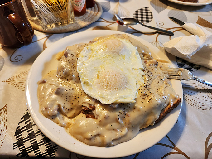 If clouds were made of gravy and biscuits, heaven would look exactly like this plate. That sunny-side-up egg is just the halo on top.
