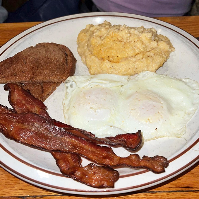 The holy trinity of breakfast: crispy bacon, toast, and eggs so perfectly cooked they deserve their own Instagram account.