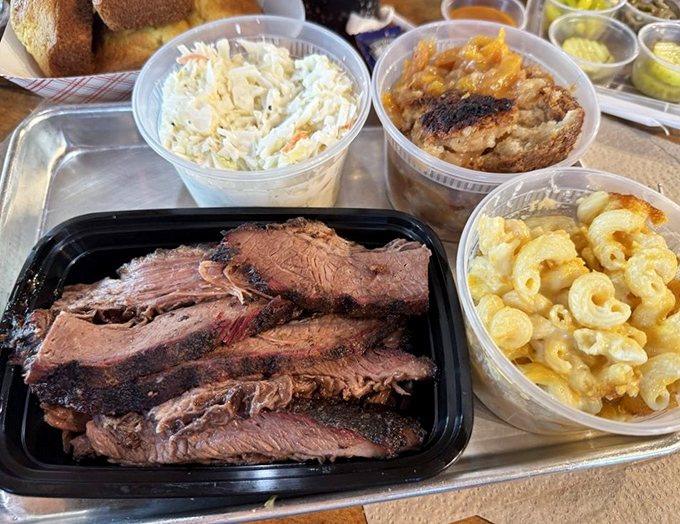 Brisket sliced to perfection alongside classic sides&mdash;proof that happiness can indeed be served on a cafeteria tray.