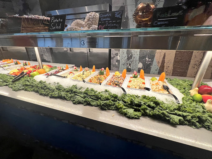 The salad bar that makes you feel virtuous before the seafood marathon begins. "I had some greens" becomes the perfect alibi.