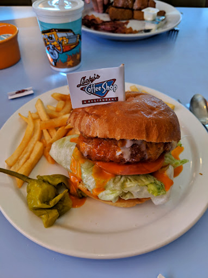 A burger that requires both hands and a strategy. That little flag isn't decoration&mdash;it's claiming territory in the name of flavor.