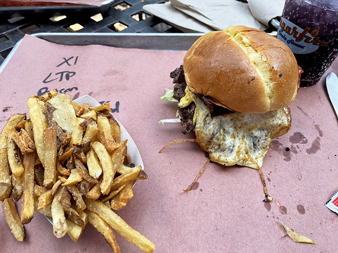 The burger that launched a thousand road trips, complete with hand-cut fries that deserve their own fan club.