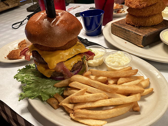 A proper burger requires proper architecture&mdash;this one's built like a delicious skyscraper with cheese cascading down like a yellow waterfall.