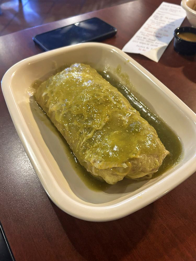 The burrito mojado swimming in vibrant green sauce is Mexican comfort food at its finest. It's not wearing a life jacket, but with flavor this good, who cares?