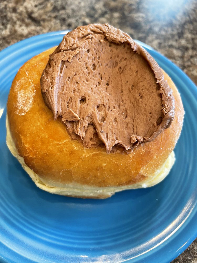 A donut wearing a chocolate beret – très chic! The golden-brown base provides the perfect canvas for that decadent chocolate topping.