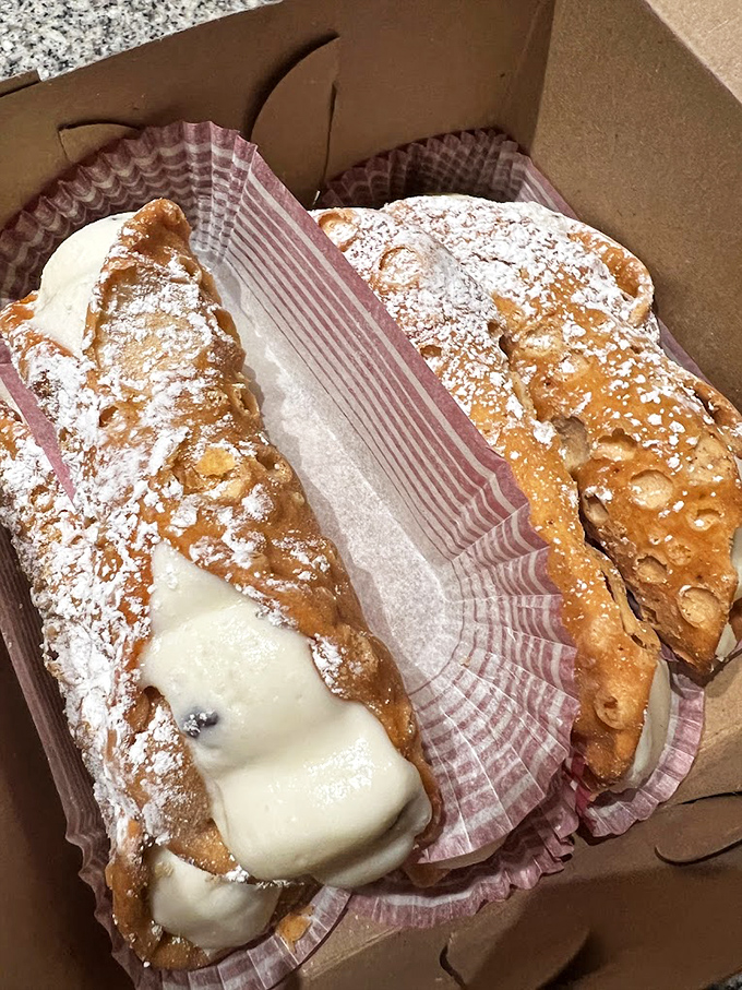 Cannoli that mean business &ndash; crisp shells dusted with powdered sugar cradle creamy filling, making you temporarily believe you've teleported to Sicily.