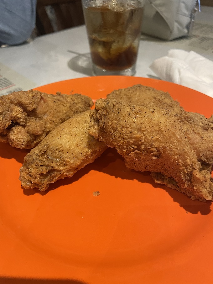 That moment when the outside world disappears and it's just you, that orange plate, and chicken so perfectly fried it deserves its own Grammy.
