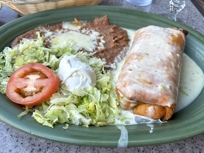 The chimichanga: where deep-frying meets dignity. This crispy miracle with its lettuce crown proves that sometimes the best things in life are indeed fried.