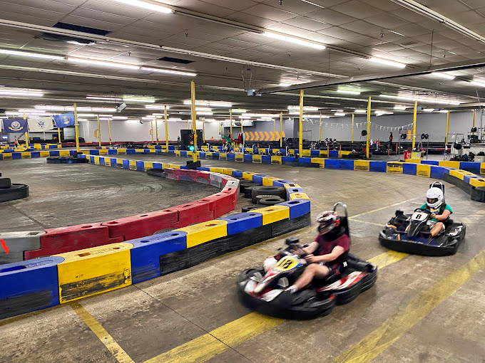 Blue and yellow barriers guide racers through this asphalt ballet. One perfect line through this curve separates champions from challengers.