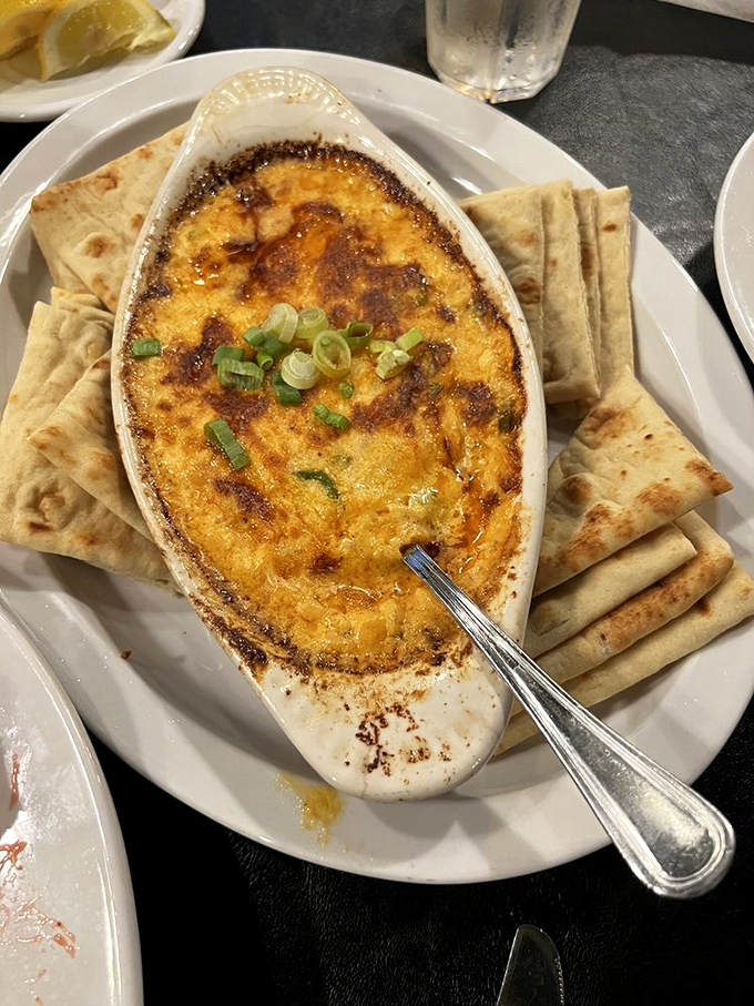 Hot, bubbling crab dip with a golden-brown top that's practically begging for those pita triangles to take a delicious dive.