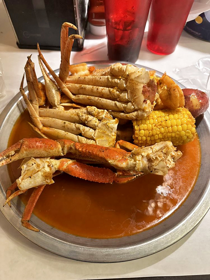 This snow crab leg is doing the backstroke in seasoned butter while corn plays lifeguard. Maritime decadence at its most photogenic.