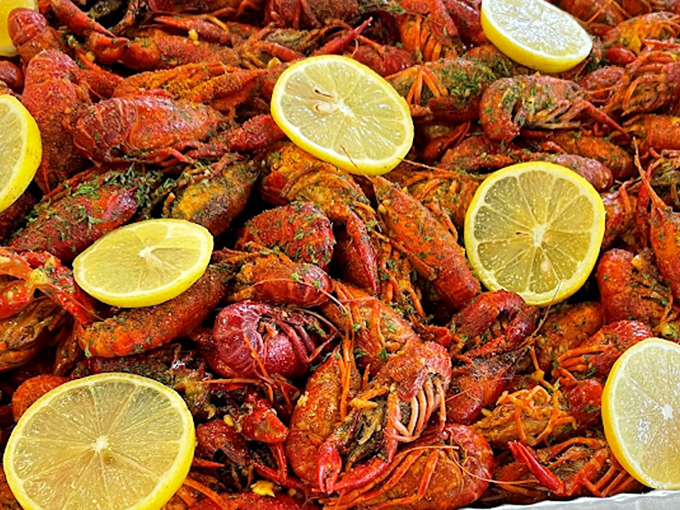 Crawfish spread across the tray like tiny red submarines on a mission to deliver explosive Cajun flavor, with lemon lifeboats standing by.