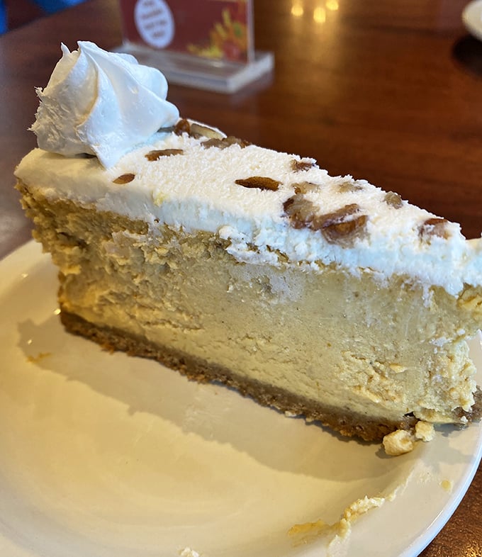 A slice of pecan-topped cheesecake so divine it should come with a warning: "May cause involuntary happy noises in public places."