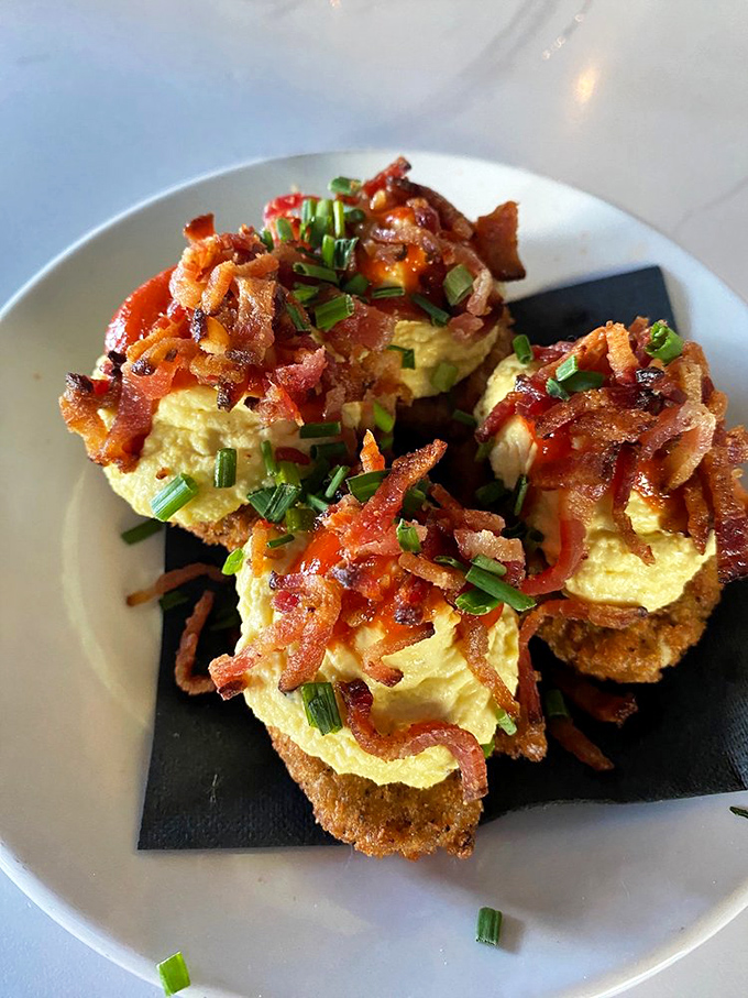 Deviled eggs living up to their mischievous name. That crispy bacon topping is like a surprise encore at a concert you already thought couldn't get better.