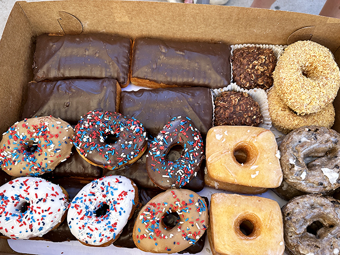 A dozen donuts in a box&mdash;the universal language of "I like you enough to share calories." Each one a different personality.